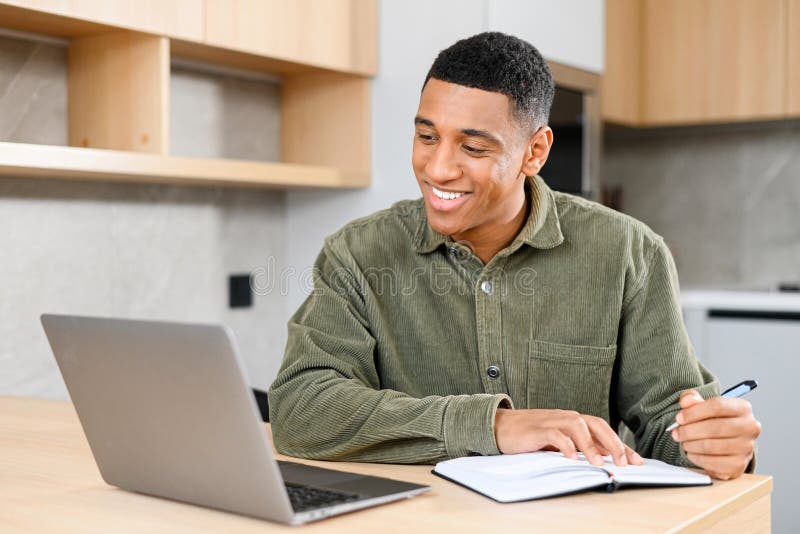 Concentrated Latin Businessman Looking at the Laptop Display, Solving ... Concentrated Latin Businessman Looking at the Laptop Display, Solving ...