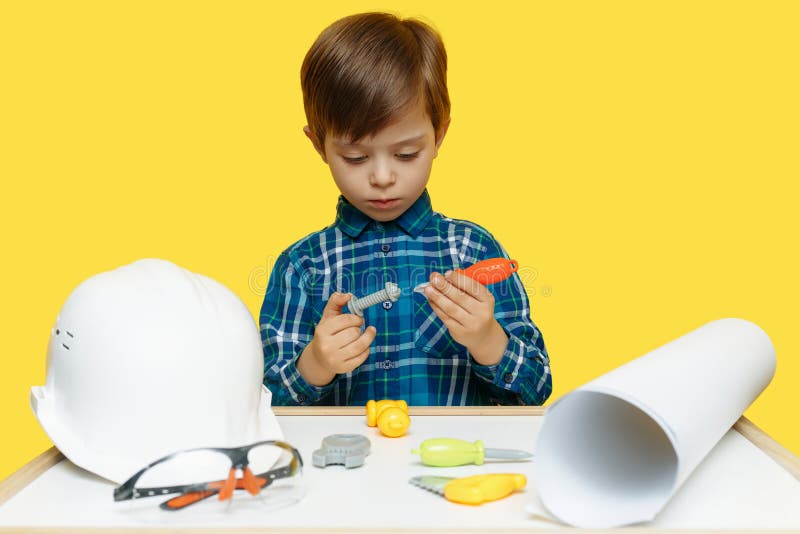 Concentrated Little Kid Boy Engineer or Architect Sitting at the Work ...