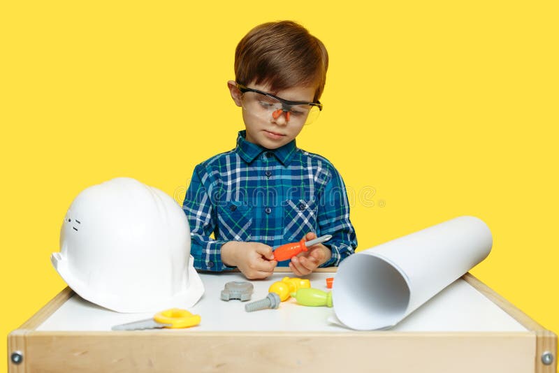 Concentrated Little Kid Boy Engineer or Architect Sitting at the Work ...