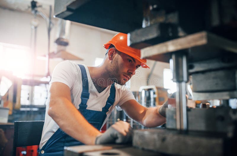 Concentrated Look. Man in Uniform Works on the Production Stock Photo ...