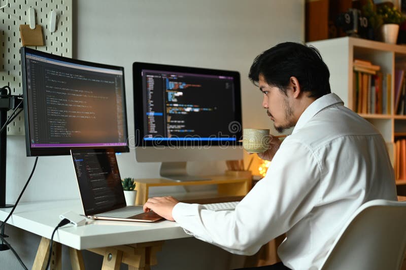 Concentrated Male Web Developer Working with Coded Data on Computer Screen. Programming and ...