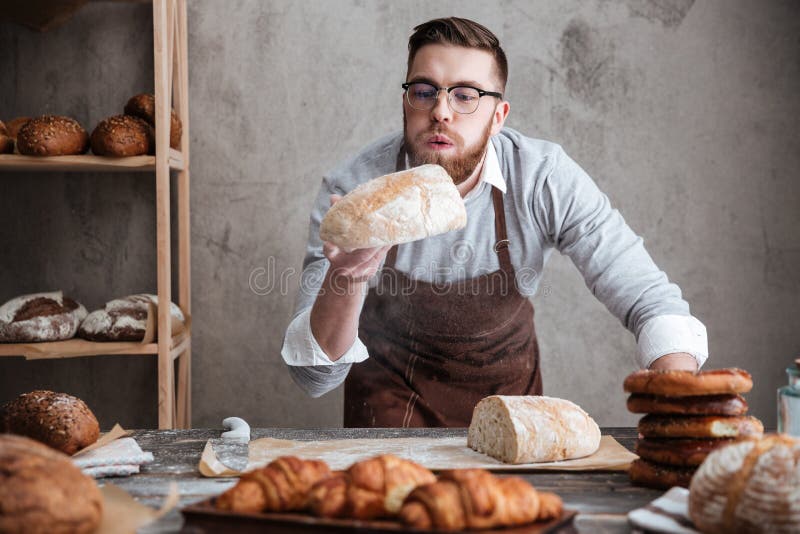 Concentrated Man Baker Standing at Bakery Holding Bread Stock Photo ...
