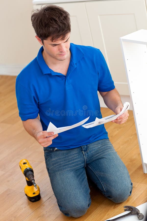 Concentrated Man Reading Instructions of Furniture Stock Image - Image ...
