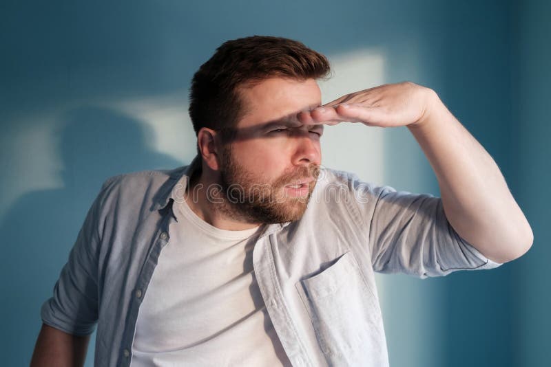 Concentrated Man is Trying To See Something in the Distance, Hiding ... Concentrated Man is Trying To See Something in the Distance, Hiding ...