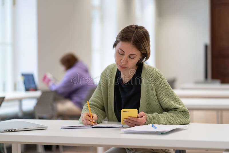 Concentrated Mature Female Student Using Smartphone for Exam ...