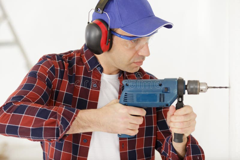 Concentrated Mature Man Drills Wall with Drill Stock Photo - Image of ...