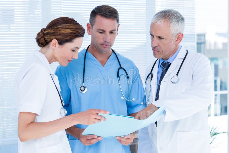 Concentrated Medical Colleagues Analyzing File Together Stock Image ...