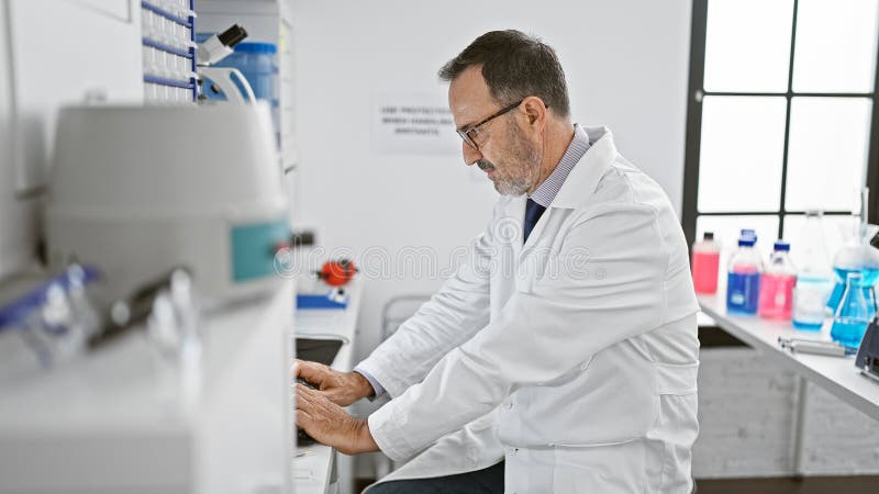 Concentrated Middle-aged Man with Grey Hair, Immersed in Groundbreaking ...