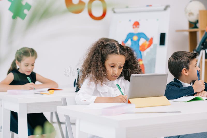 Concentrated Multiethnic Schoolkids Studying with Exercise Books and ...