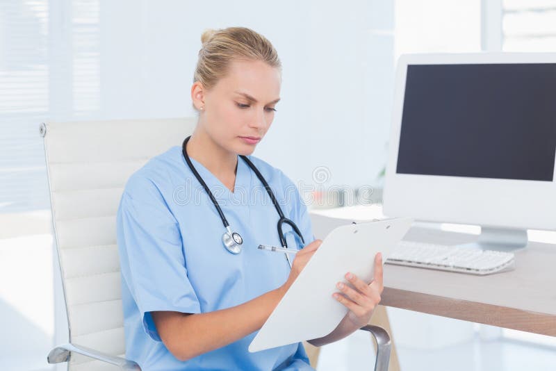 Concentrated Nurse Writing on Clipboard Stock Image - Image of keyboard ...