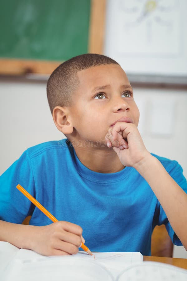 Concentrated Pupil Working at His Desk in a Classroom Stock Image ...