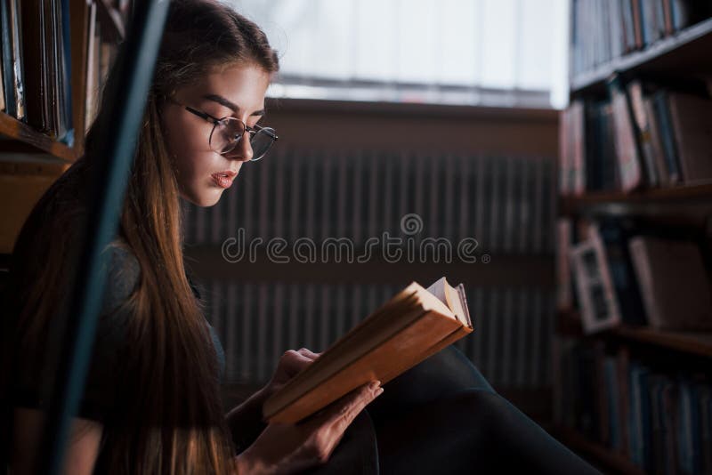 Concentrated at Reading. Female Student is in Library that Full of ...