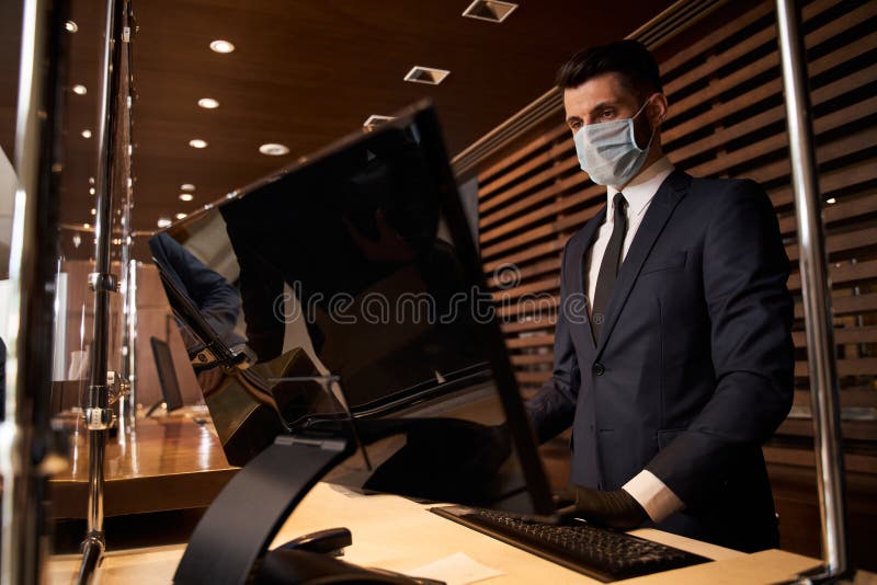 Concentrated Receptionist Using Computer at His Workplace Stock Image ...