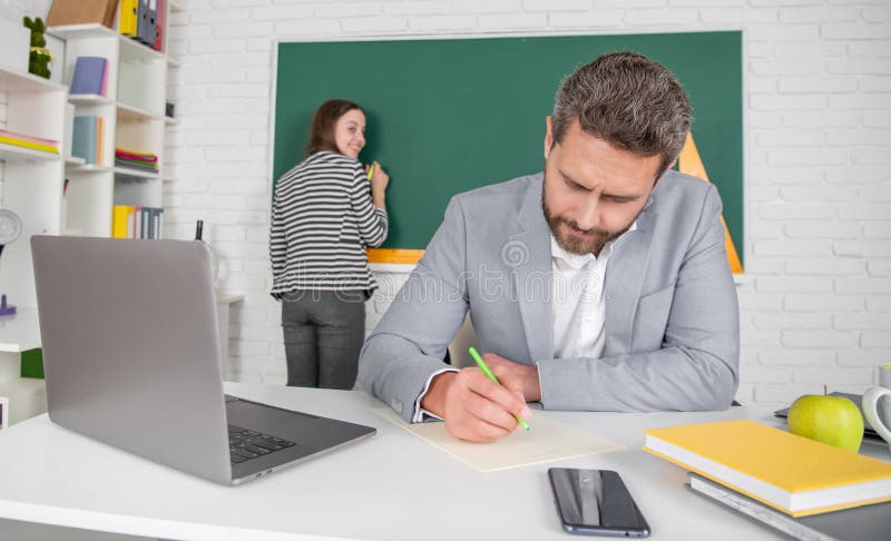 Concentrated School Teacher in Classroom with Selective Focus of Kid at ...