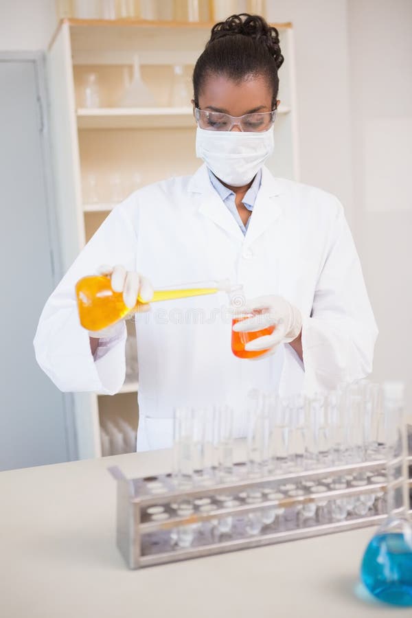 Concentrated Scientist Pouring Orange Fluid Stock Image - Image of ...