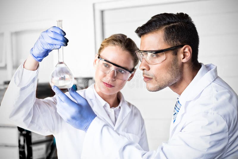 Lab Scientist Examining Beaker, Horizontal Stock Image - Image of ...