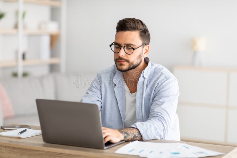 Concentrated Self-entrepreneur Working with Laptop at Home Office ...