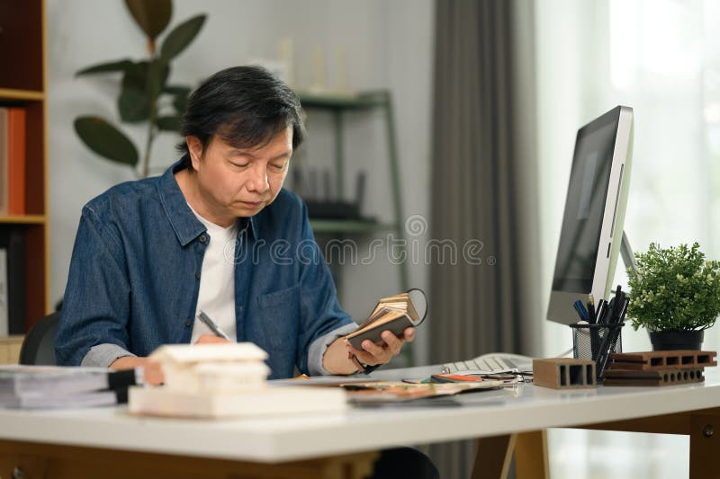 Concentrated Senior Male Architect Working on New Project at His Home ...