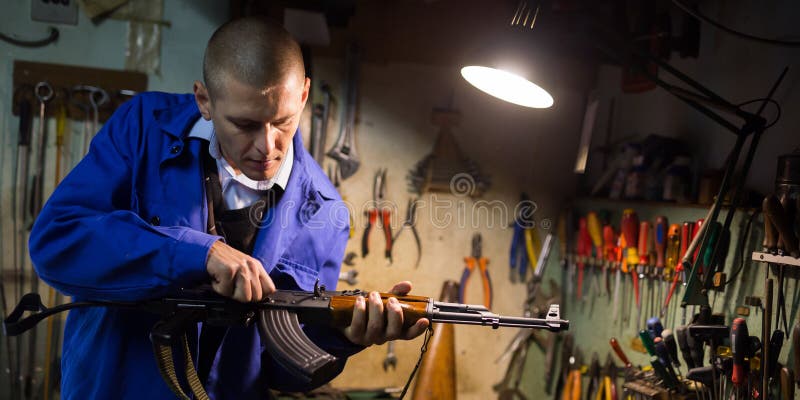 Gunsmith with Kalashnikov Assault Rifle in Weapons Workshop Stock Image ...