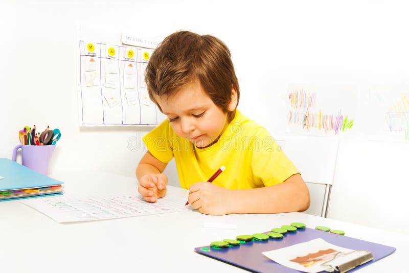 Concentrated Small Boy Write with Pencil Alone Stock Image - Image of ...