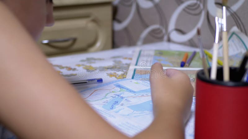 Concentrated, Smart School Boy is Studying Map, Geography. Online Home ...