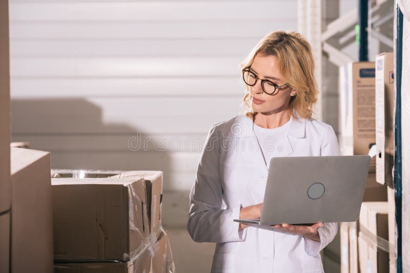Concentrated Storekeeper Using Laptop while Looking Stock Photo - Image ...