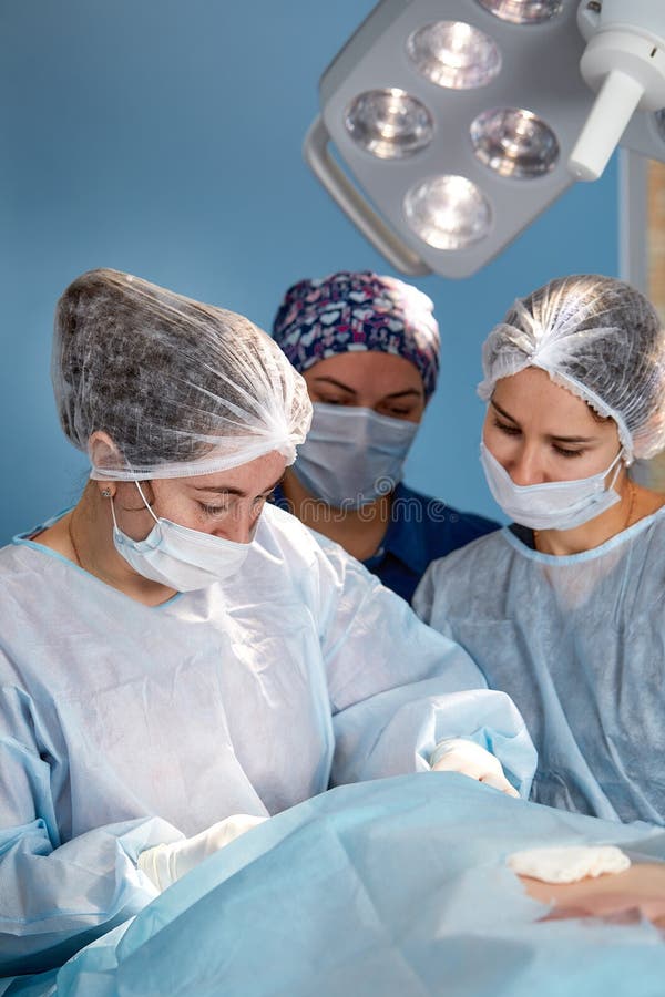 Concentrated Surgical Team Operating a Patient in an Operation Theater ...
