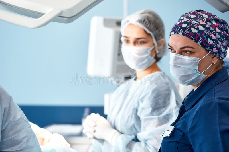 Concentrated Surgical Team Operating a Patient in an Operation Theater ...