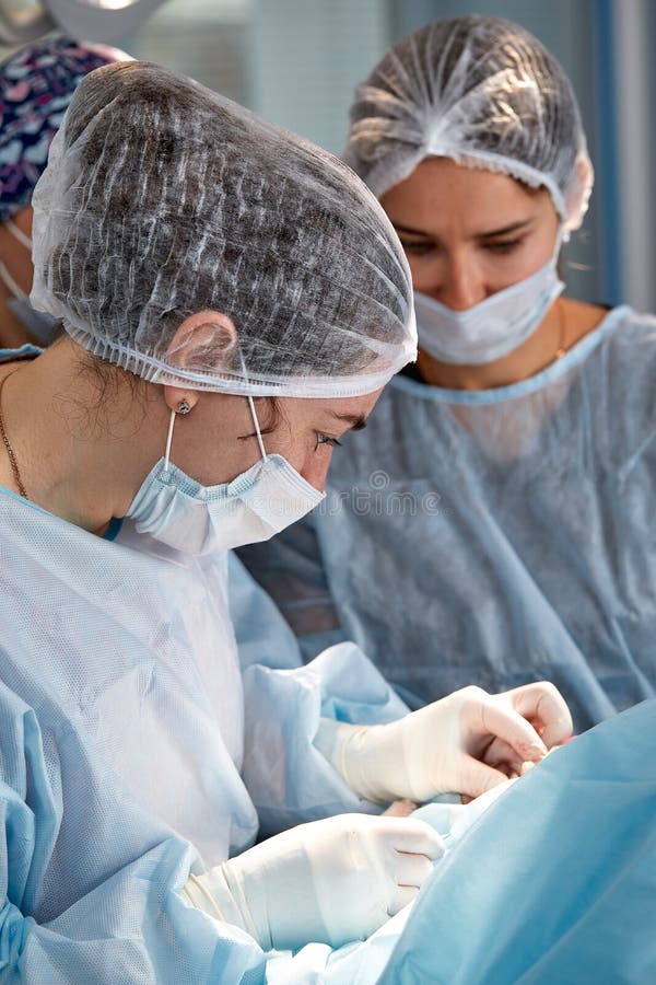 Concentrated Surgical Team Operating a Patient in an Operation Theater ...