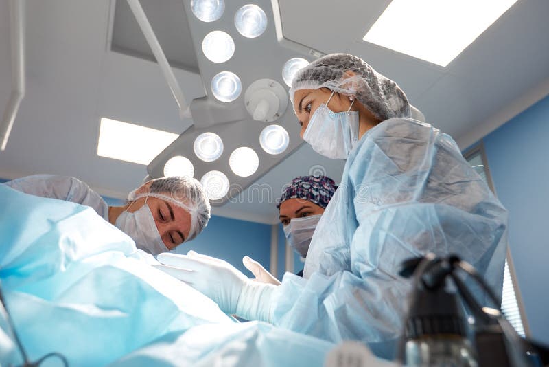 Concentrated Surgical Team Operating a Patient in an Operation Theater ...