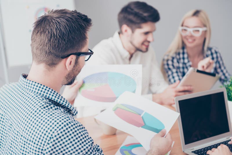 Concentrated Three Young Managers Working Together while Sitting at ...