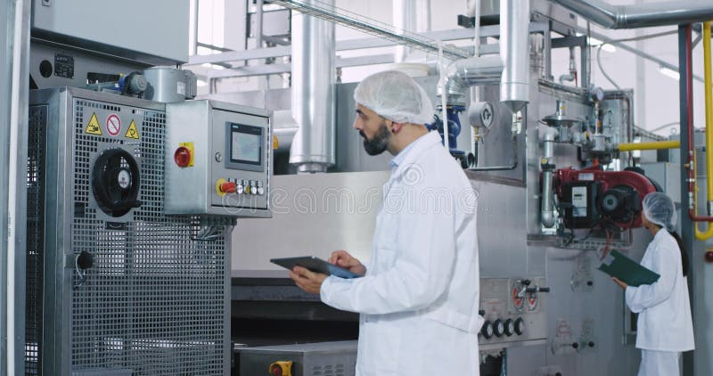 Concentrated Two Engineers in a Big Manufacturing Industry Have a ...