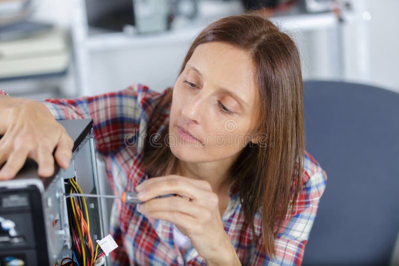 Concentrated Woman Fixing Desktop Computer Seated at Table Stock Image ...