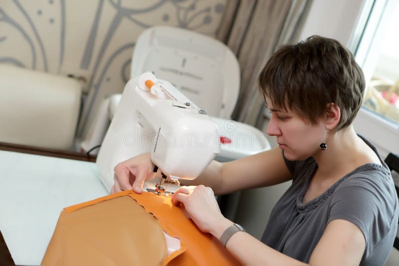 Concentrated Woman Using Sewing Machine Stock Photo - Image of creative ...