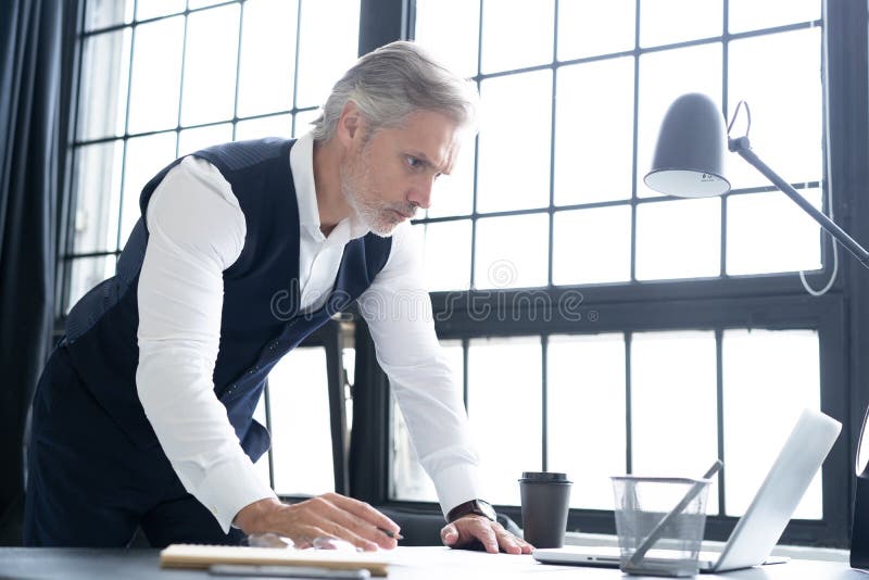 Concentrated at Work. Mature Man in Full Suit Using Laptop while ...