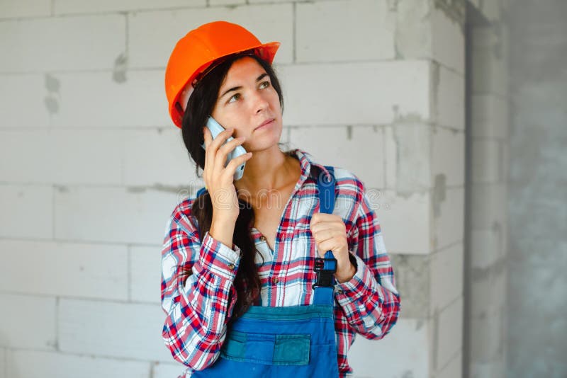Concentrated Worker Woman in Blue Overall Having Phone Conversation ...