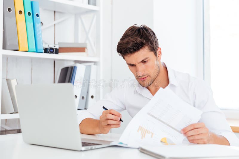 Concentrated Young Businessman Sitting and Writing at the Table Stock ...