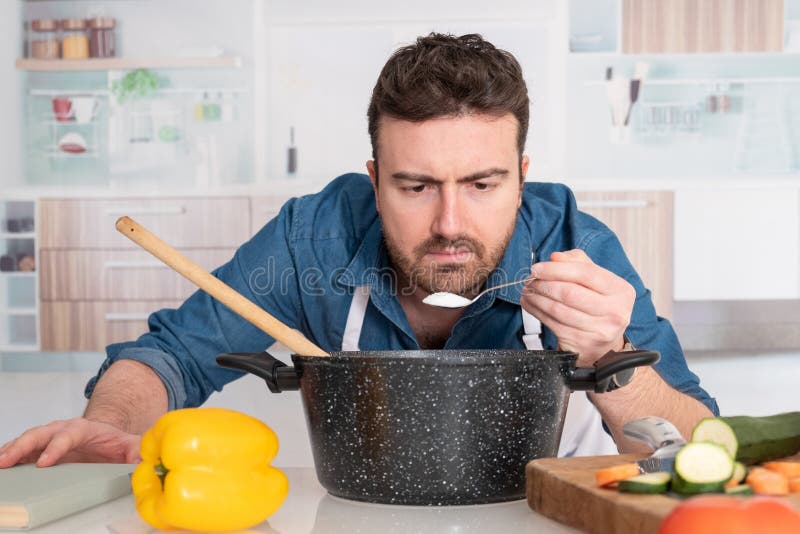 Concentrated Young Man Preparing Food at Home Stock Photo - Image of ...