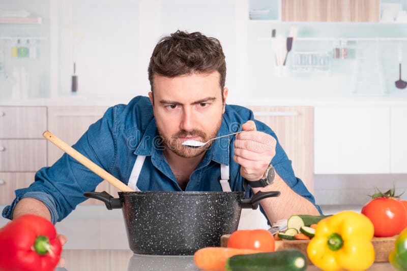 Man is Cooking in His Kitchen and Adding Ingredient Stock Photo - Image ...
