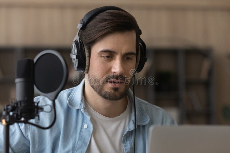 Concentrated Young Man Singing Song Looking at Computer Screen. Stock ...