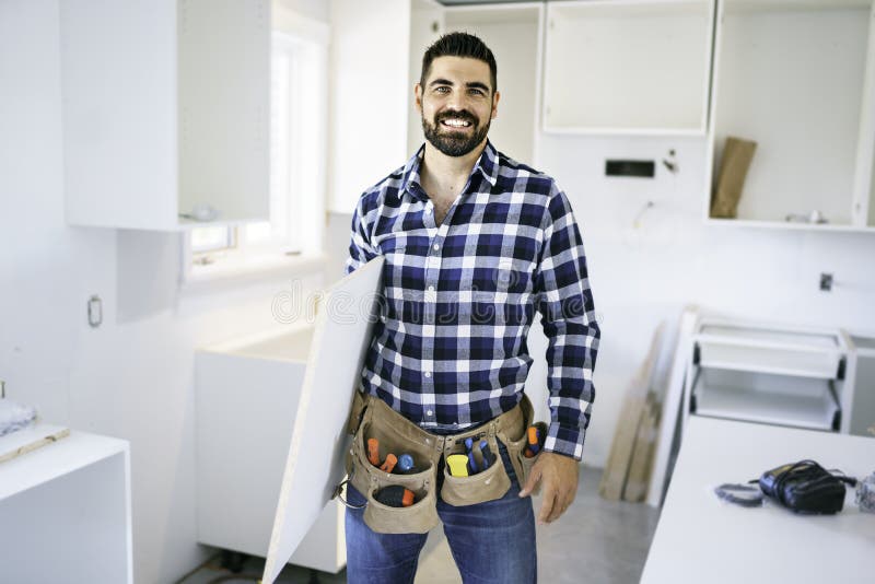 Concentrated Young Man Work with White Cabinet in the Kitchen Stock ...