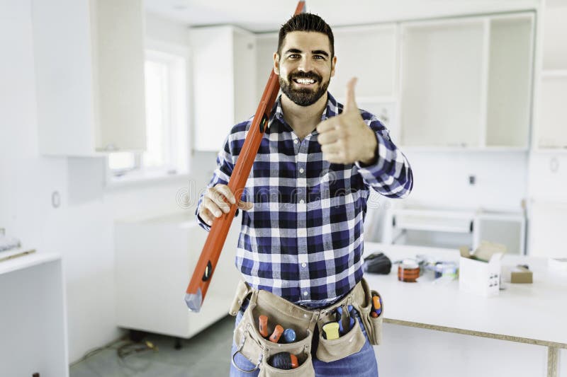 Concentrated Young Man Work with White Cabinet in the Kitchen with ...