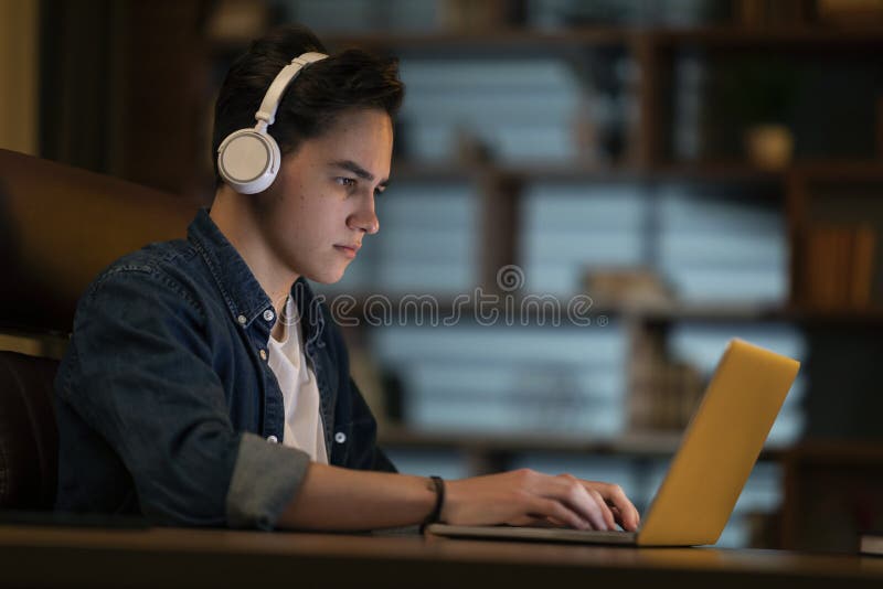 Concentrated Young Man Working on Laptop at Dark Office Stock Image ...