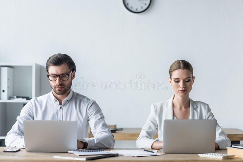 Concentrated Young Managers Working with Laptops Together Stock Photo ...