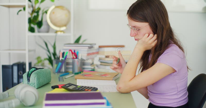 Concentrated Young Student Doing Homework and Studying at Her Desk ...