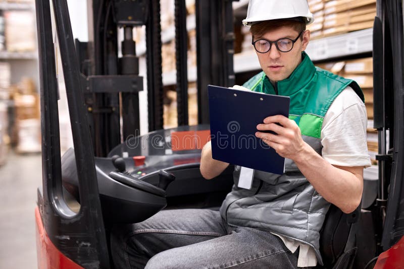 Concentrated Young Warehouse Worker in Production Department of Modern ...