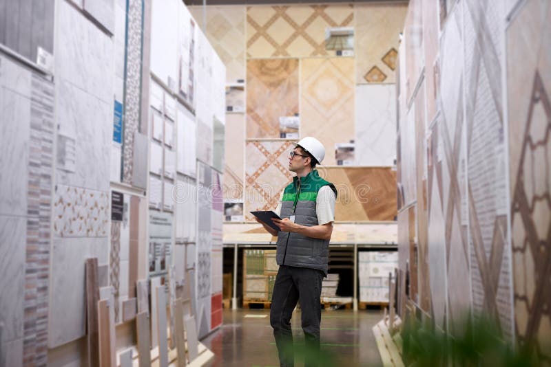 Concentrated Young Warehouse Worker in Production Department of Modern ...