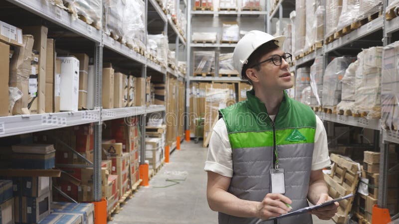 Concentrated Young Warehouse Worker in Production Department of Modern ...