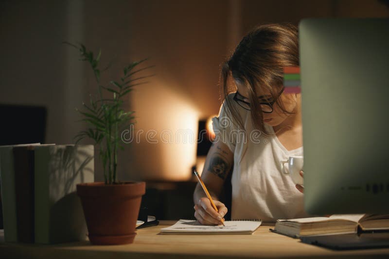 Concentrated Young Woman Designer Writing Notes Using Computer Stock ...