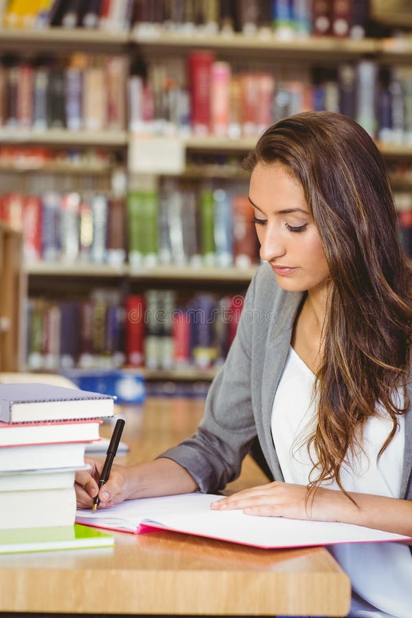 Concentrating Brunette Student Doing Her Assignment Stock Image - Image ...